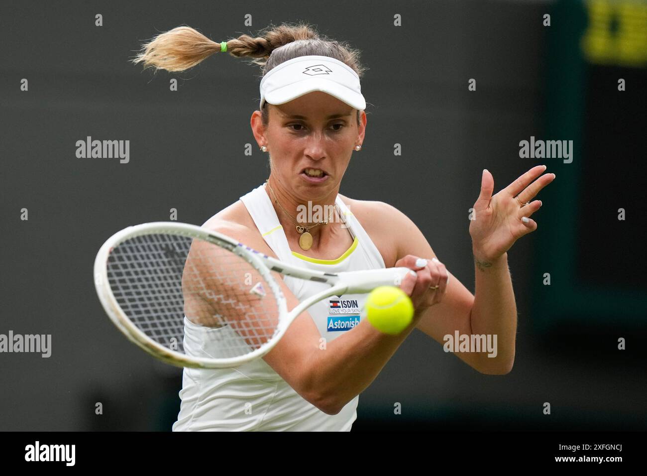 Elise Mertens of Belgium plays a forehand return to Emma Raducanu of ...