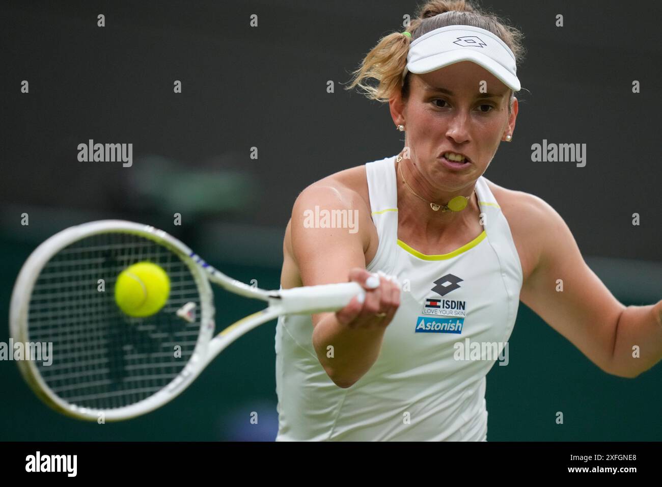 Elise Mertens of Belgium plays a forehand return to Emma Raducanu of ...