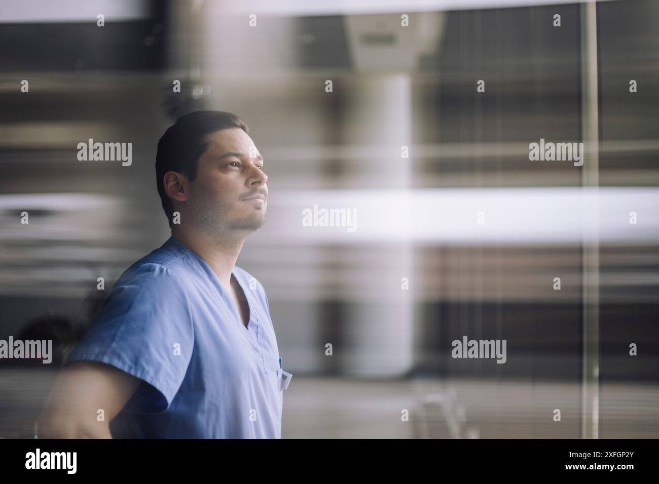 Doctor looking through glass hi-res stock photography and images - Alamy