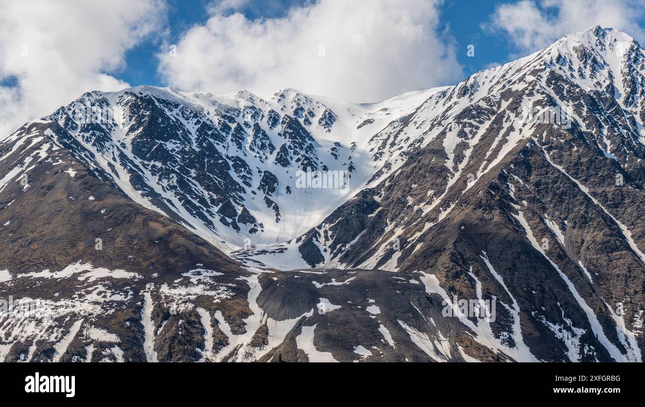 Snow capped mountain top in northern Canada, Yukon Territory with blue ...