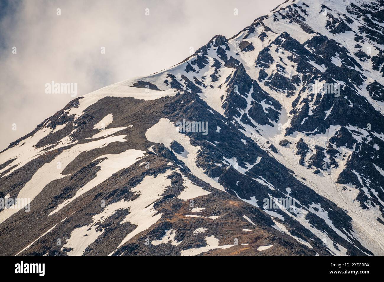 Snow capped mountain top in northern Canada, Yukon Territory with blue ...