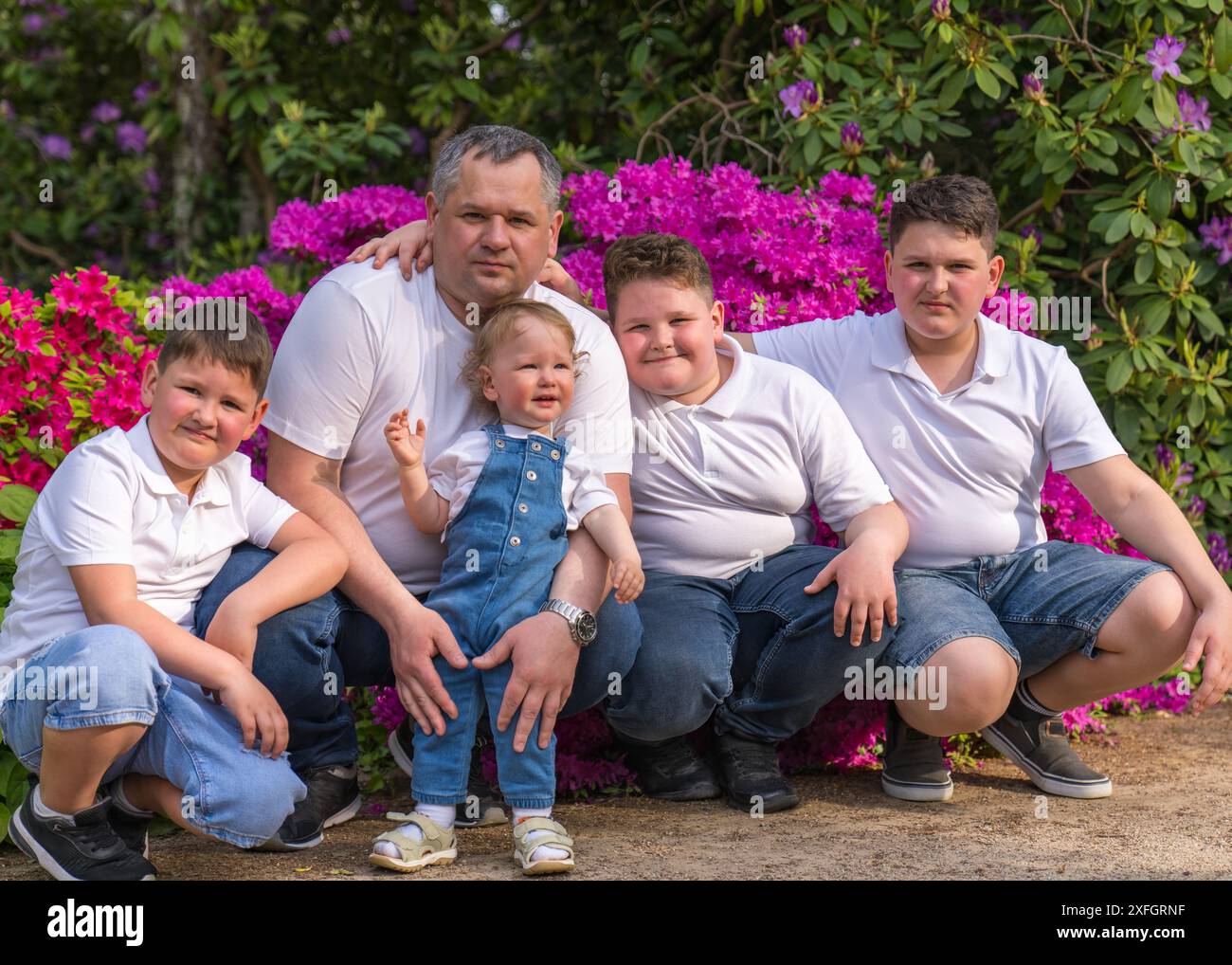 Portrait of a large, cheerful family on a floral background. Happy dad ...