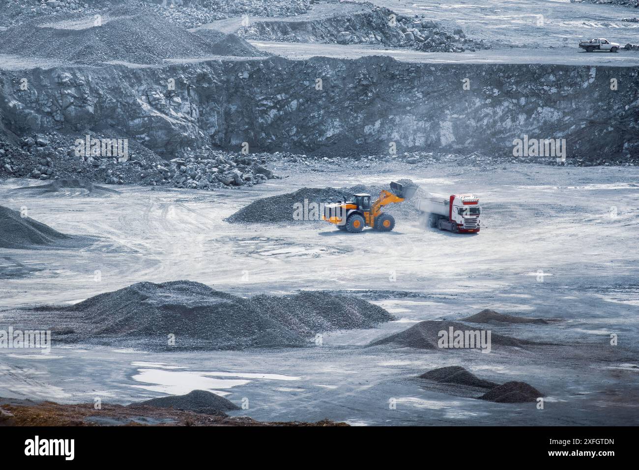 Loader filling a dump truck in an expansive diabase quarry. Parekklisia ...