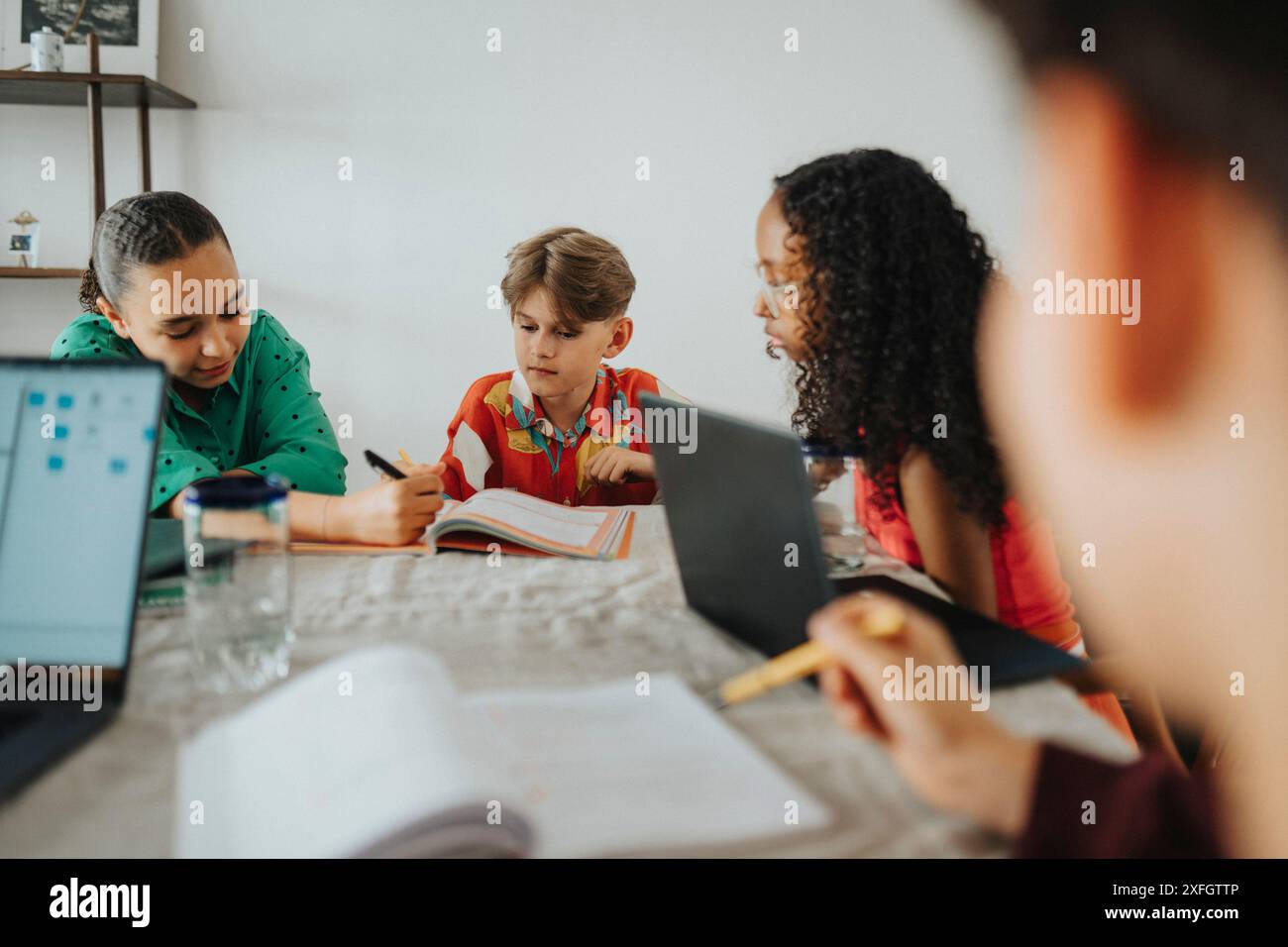 Child helping friend at school hi-res stock photography and images - Alamy