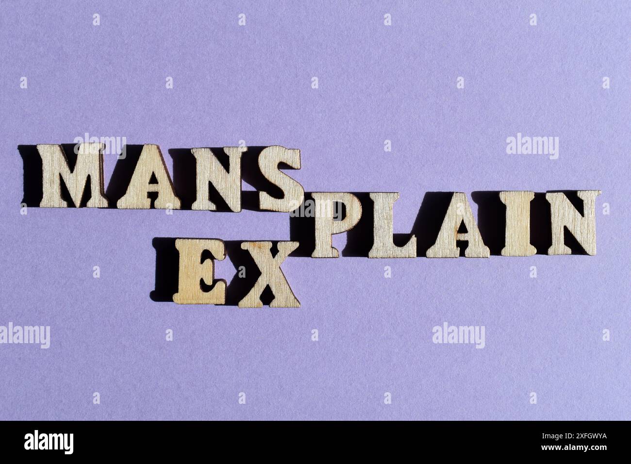 Mansplain, Explain, words in wooden alphabet letters isolated on ... Mansplain, Explain, words in wooden alphabet letters isolated on ...