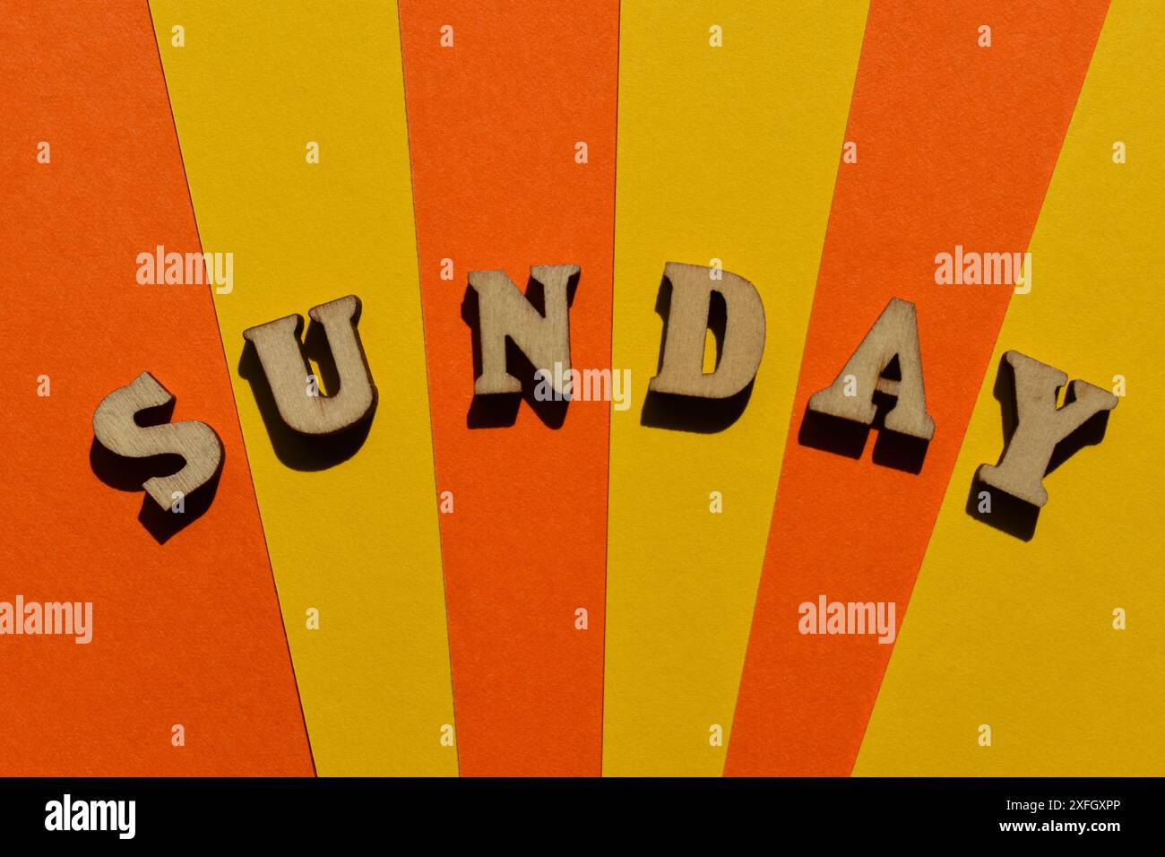 Sunday, word in wooden alphabet letters isolated on bright yellow and ...