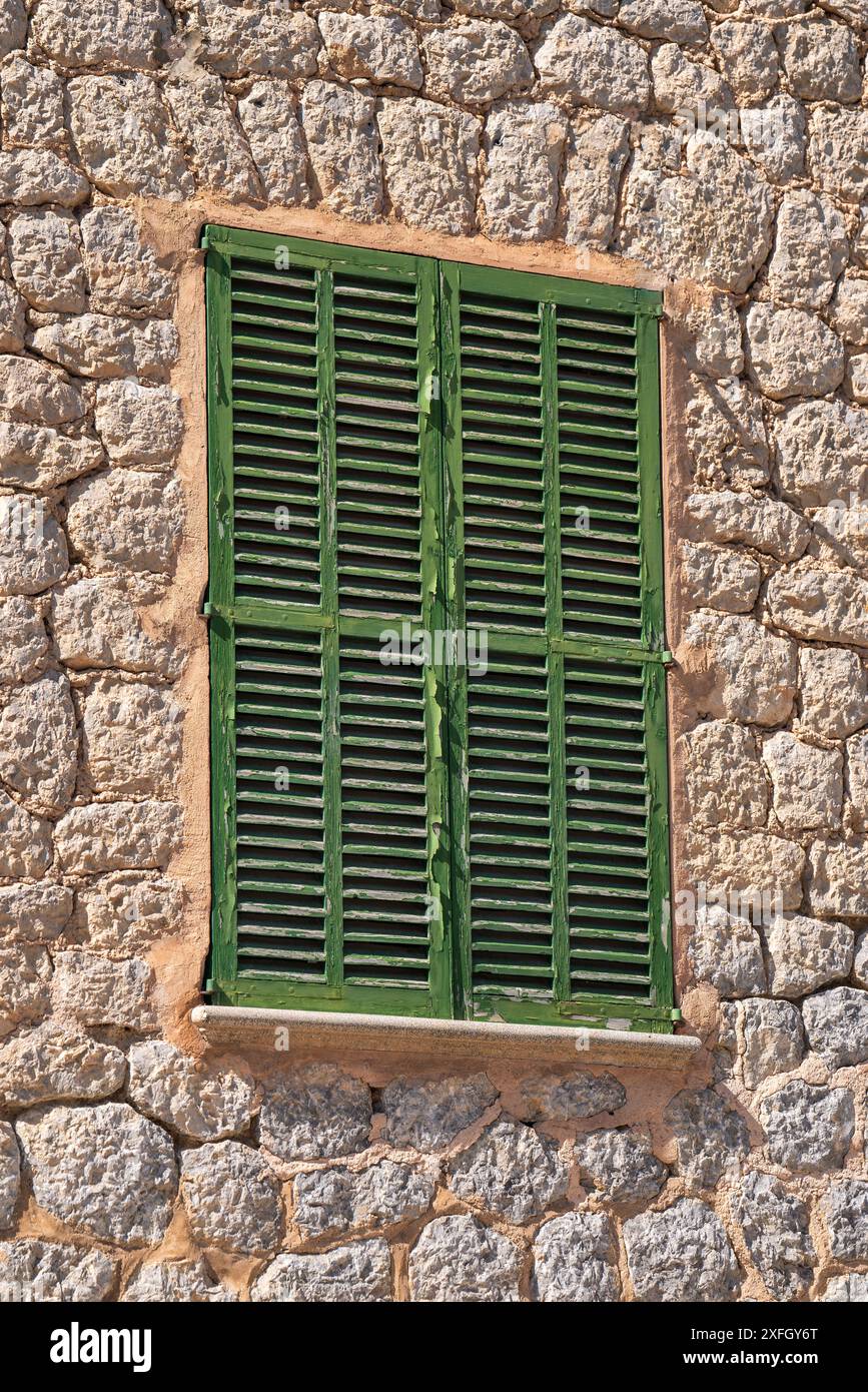 A small window with closed green shutters. Mallorca, Mediterranean Sea ...