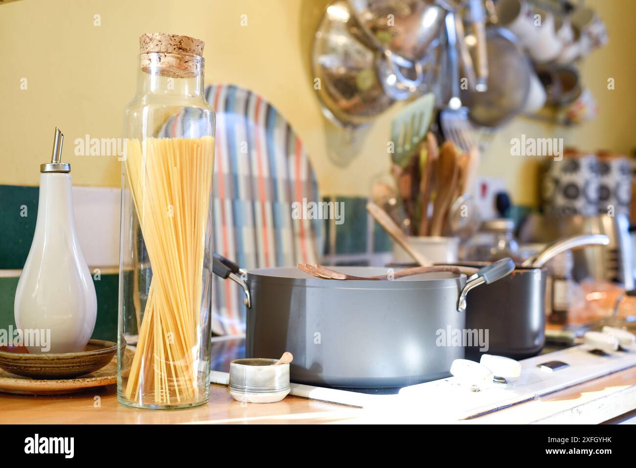 Cooking pasta in a home kitchen interior the pan has boiling water to ...