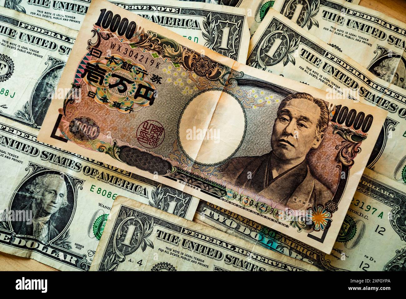 July 3, 2024, Tokyo, Japan: Stock images of a 10,000 Yen note and $1 US ...