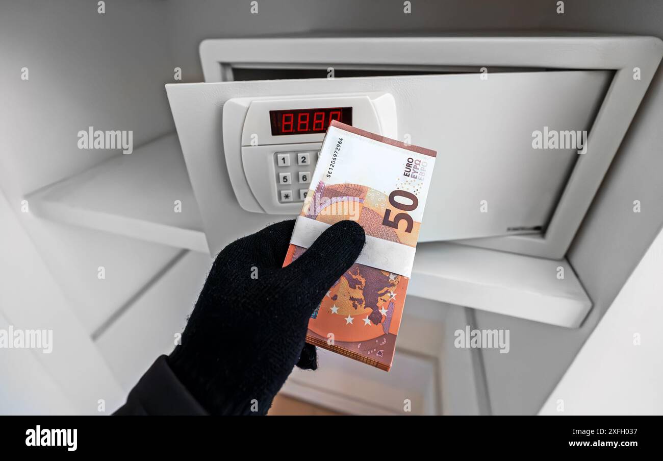 Thief stealing money from safe hi-res stock photography and images - Alamy