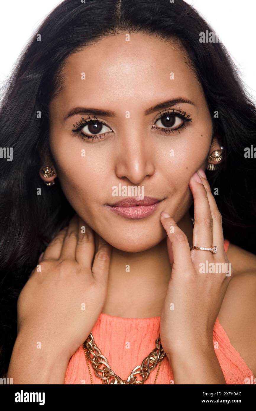 pretty indonesian girl with dark skin look at camera while being ...