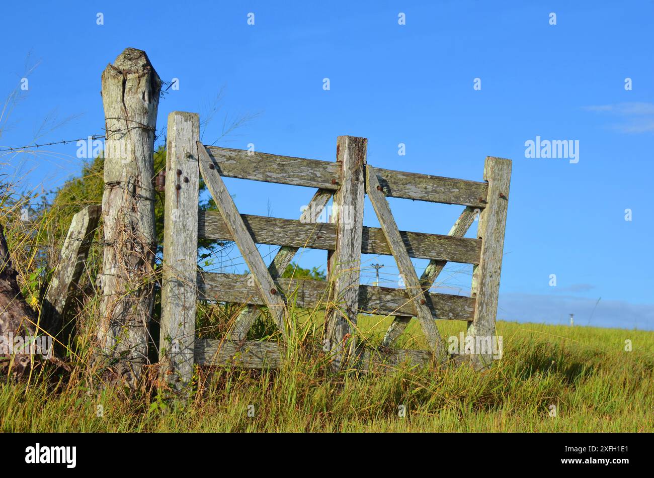 Rustic rural farm gate overlooking a beautiful blue sky Stock Photo - Alamy