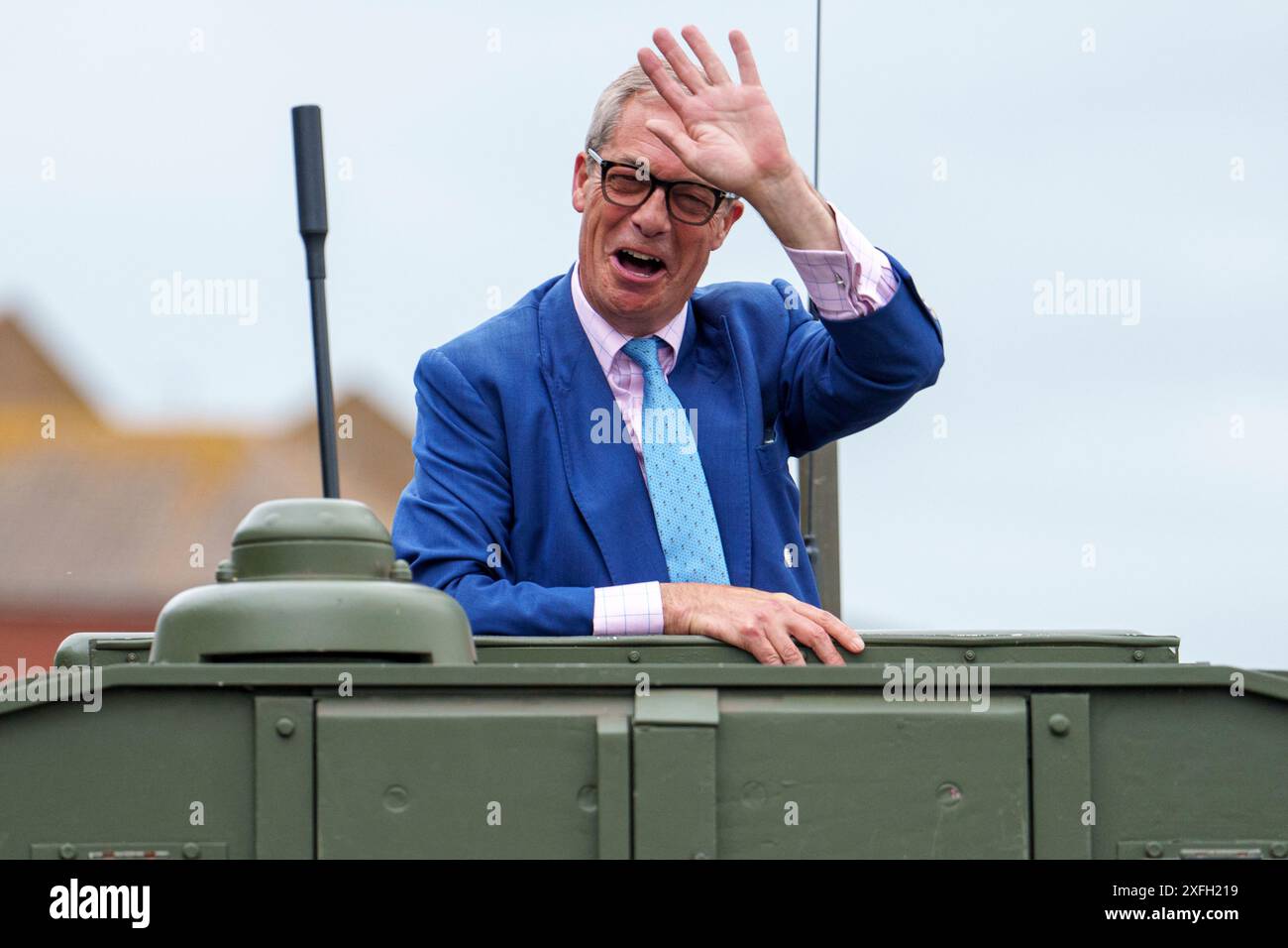 Nigel Farage, leader of the Reform UK waves from inside a jeep at the ...