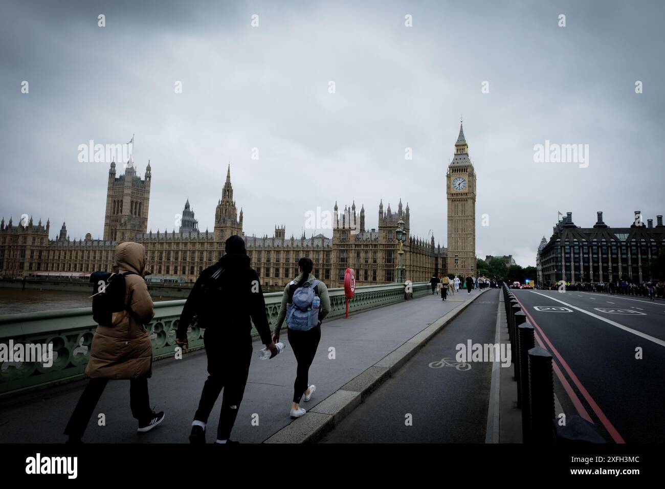 London, United Kingdom. 3rd July, 2024. People walk in winter coats in ...