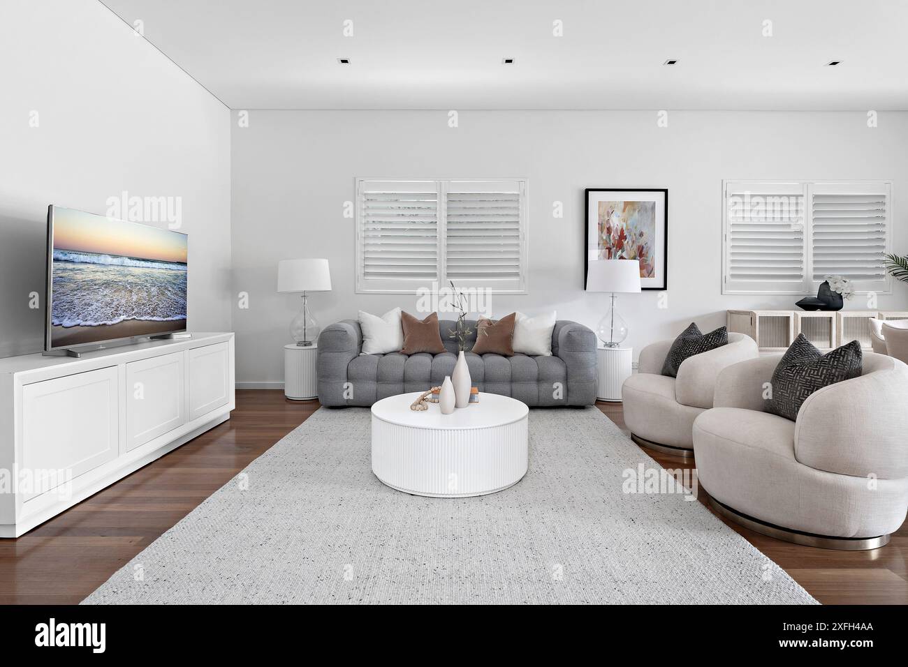 A Modern living room with stylish furniture, neutral colors, and a flat ...