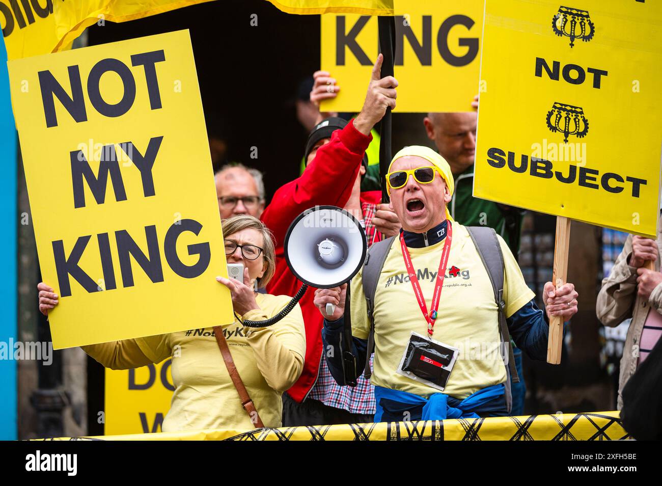 Anti monarchy protesters line the Royal Mile as members of the Royal ...