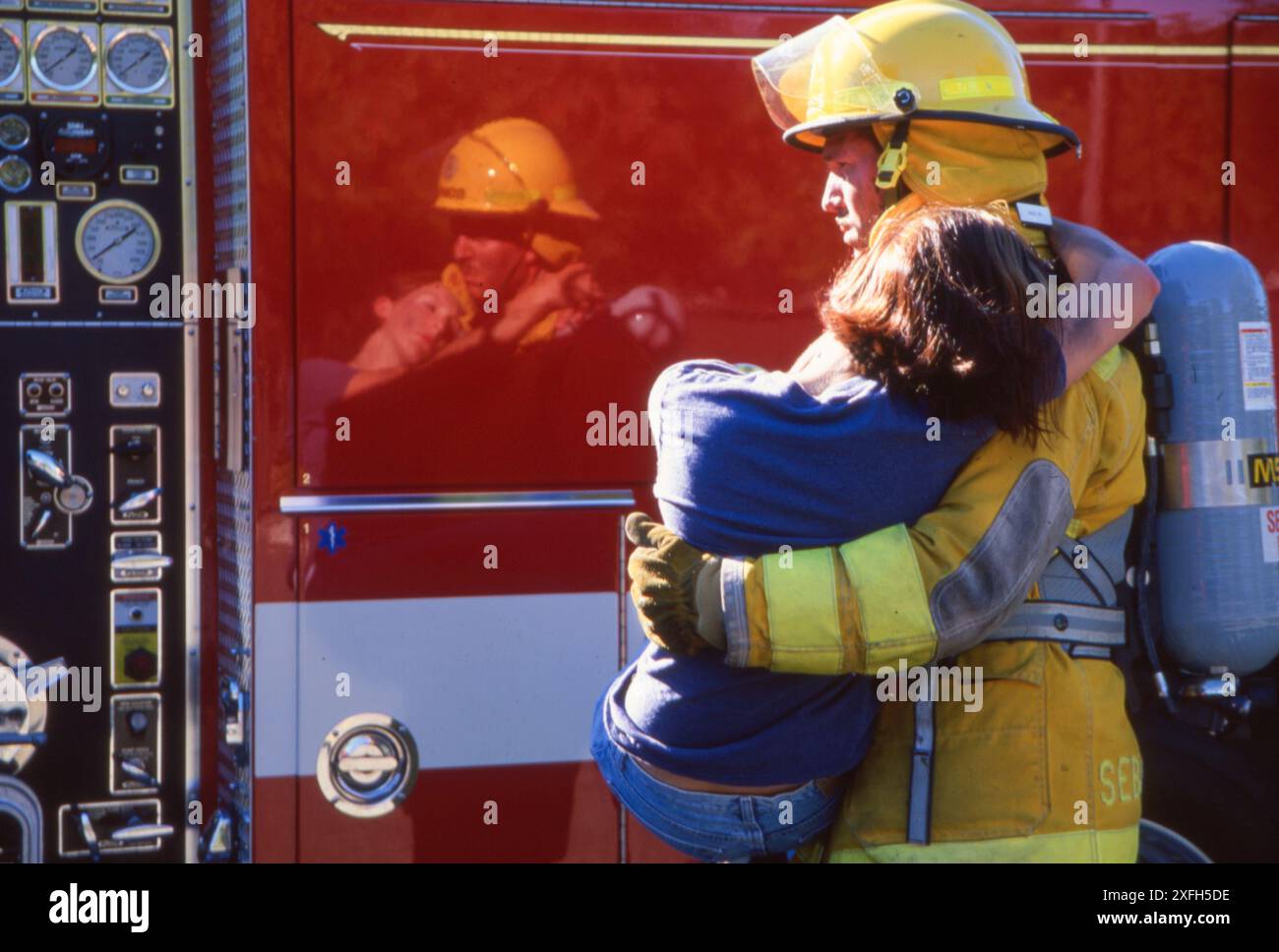 Fireman Rescuing a Young Girl at a Fire Scene, USA Stock Photo - Alamy