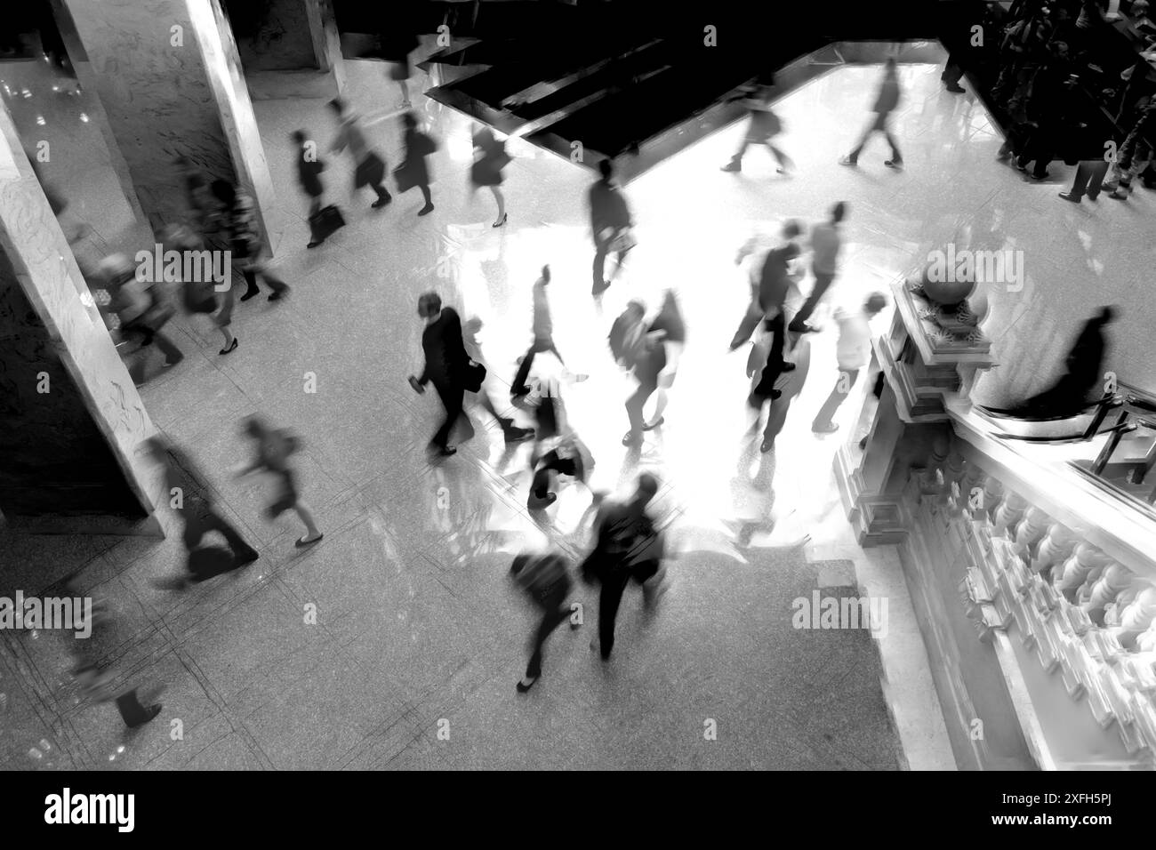 High angle view of office workers walking through office building lobby ...
