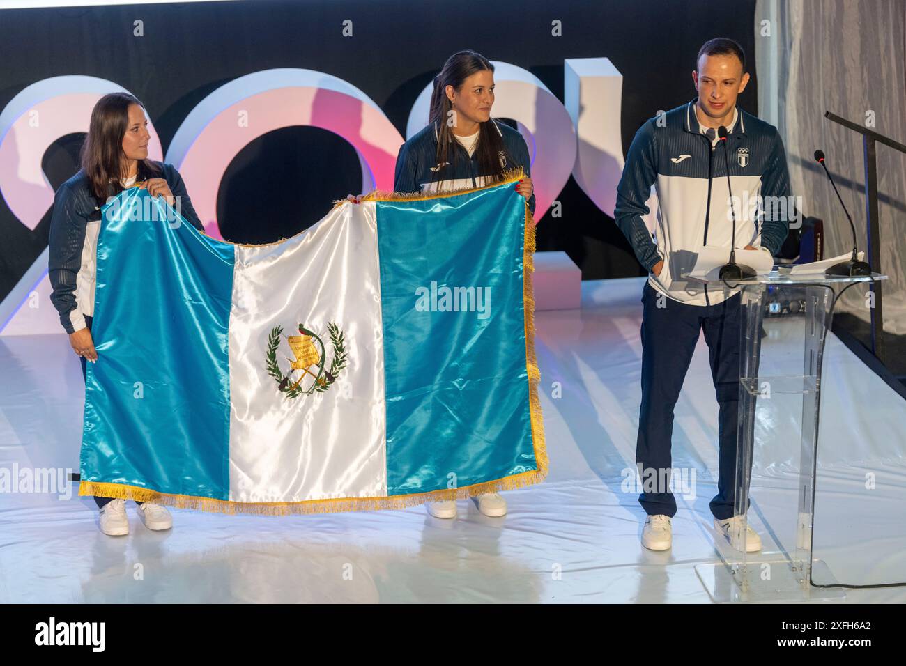 Flag bearer Kevin Cordon, right, speaks as Adriana Ruano and Ana ...