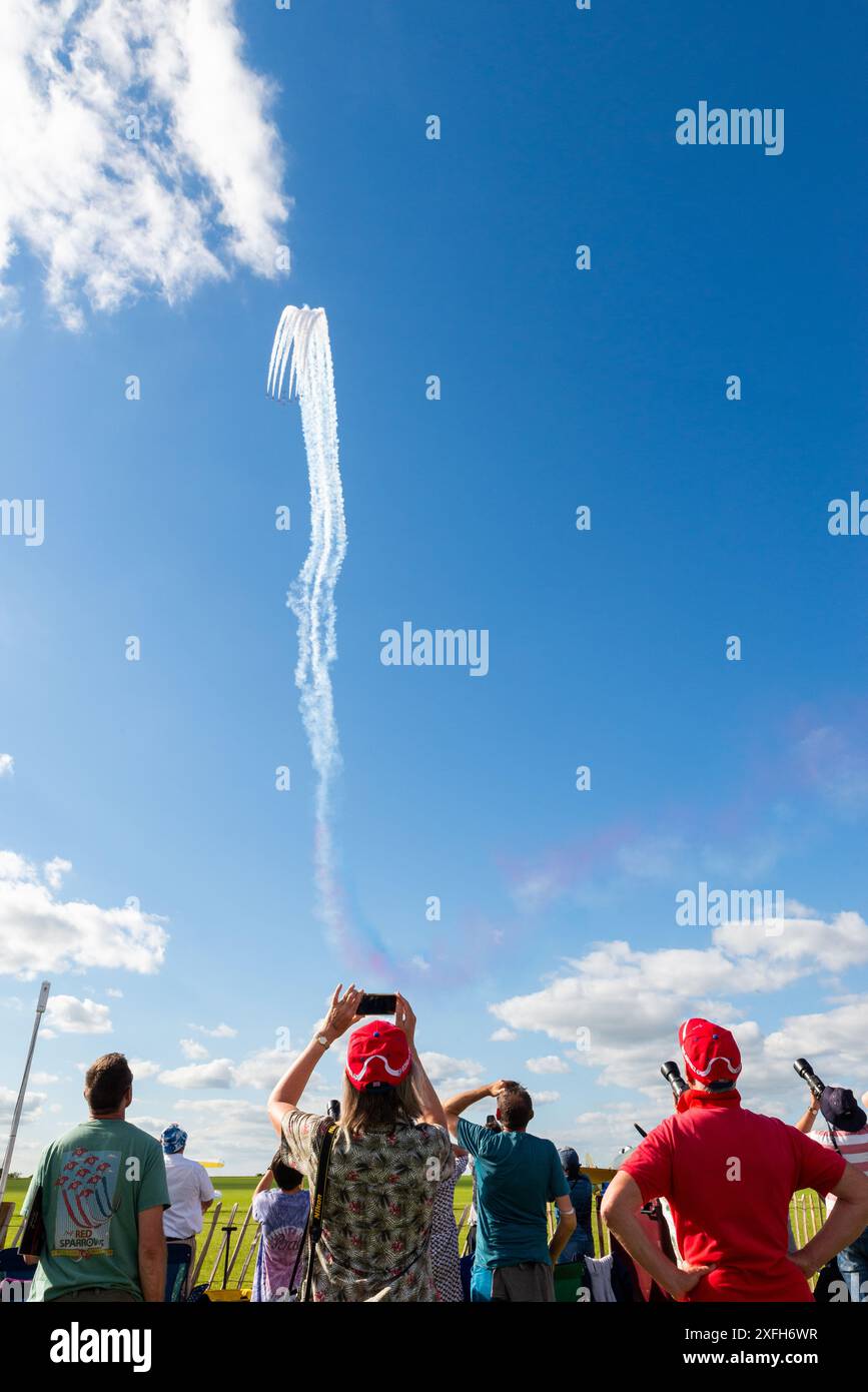 Royal Air Force Red Arrows display team dropping down from a high loop ...