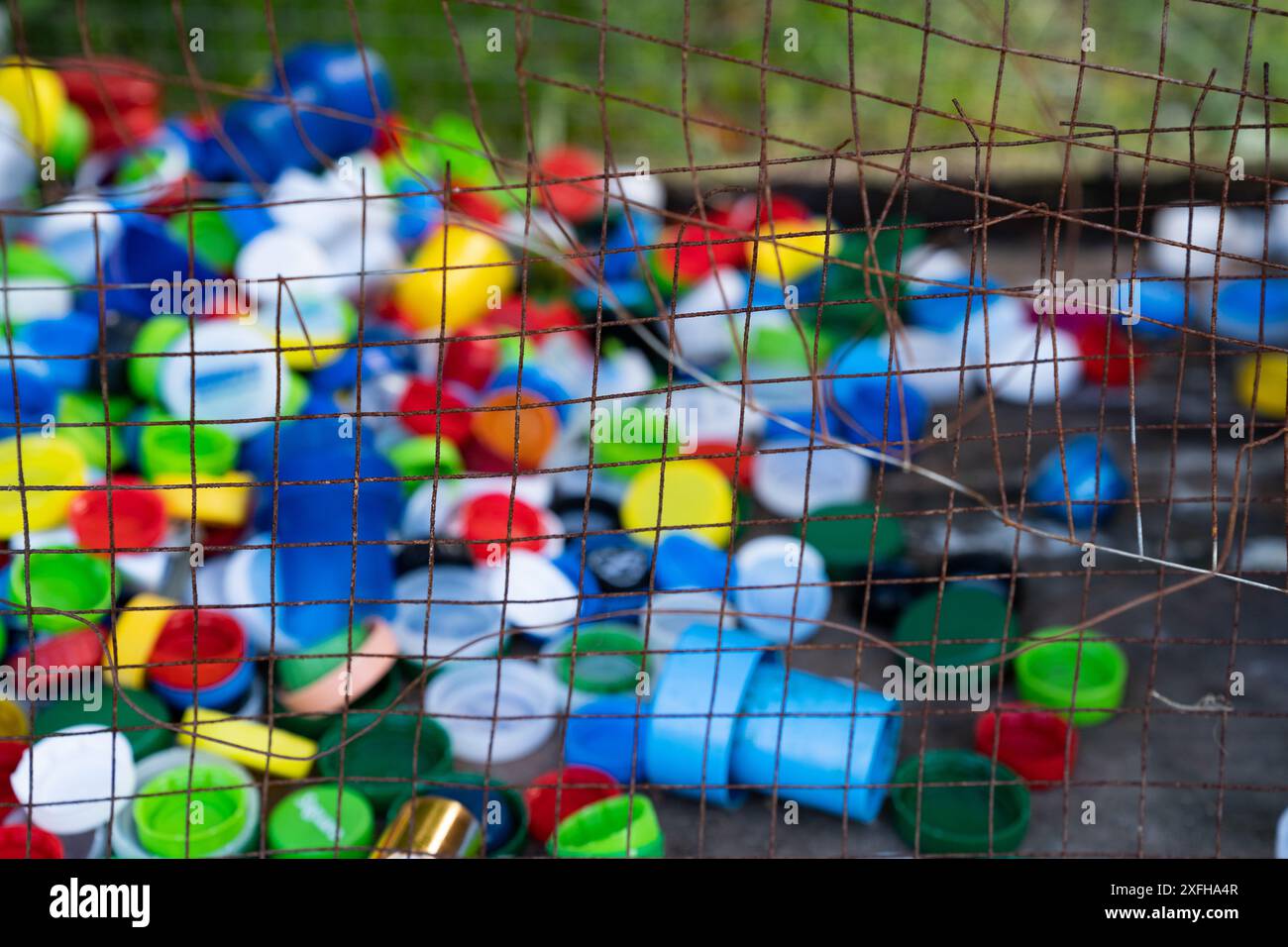 Container with plastic bottle caps Stock Photo - Alamy