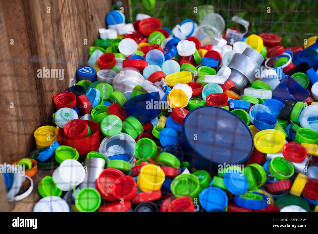 Container with plastic bottle caps Stock Photo - Alamy