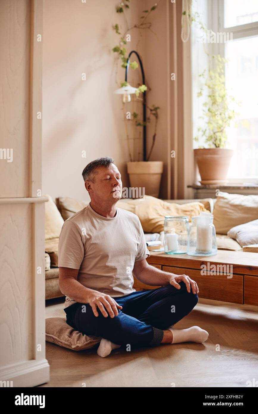 Sitting cross legged sitting meditation hi-res stock photography and ...