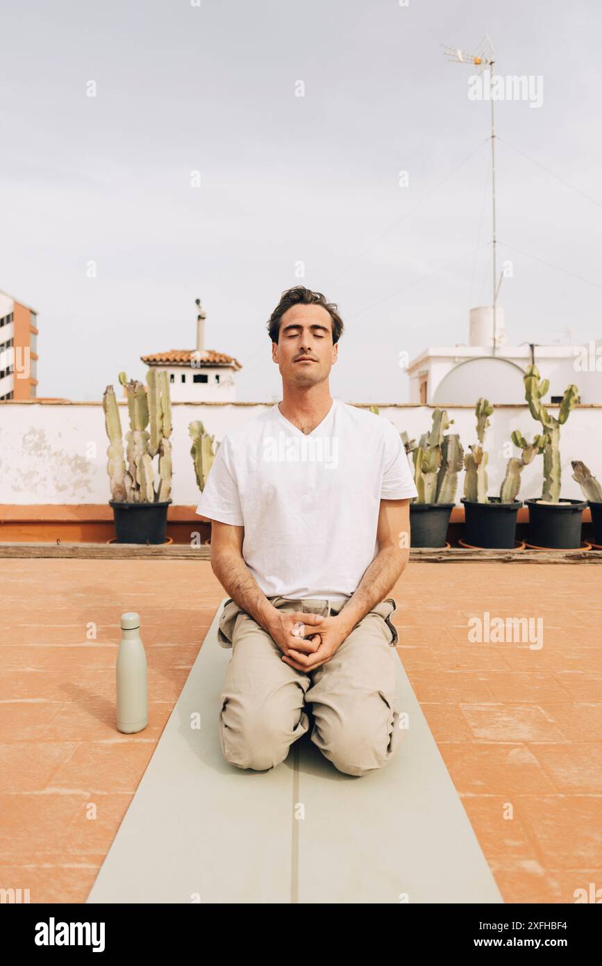 Man sitting on rooftop terrace hi-res stock photography and images - Alamy