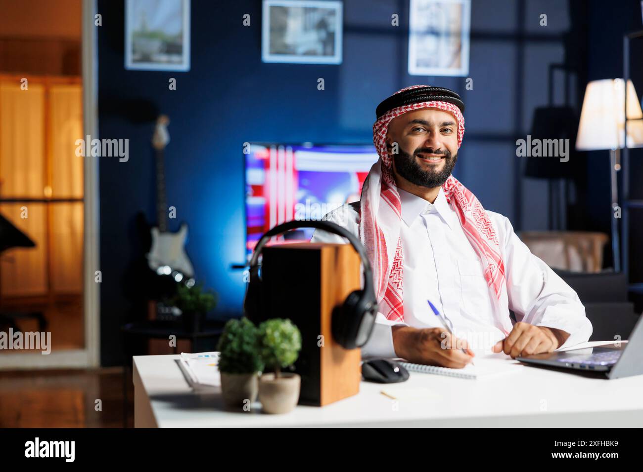 Portrait shot of Muslim man freelancer using laptop to browse the ...
