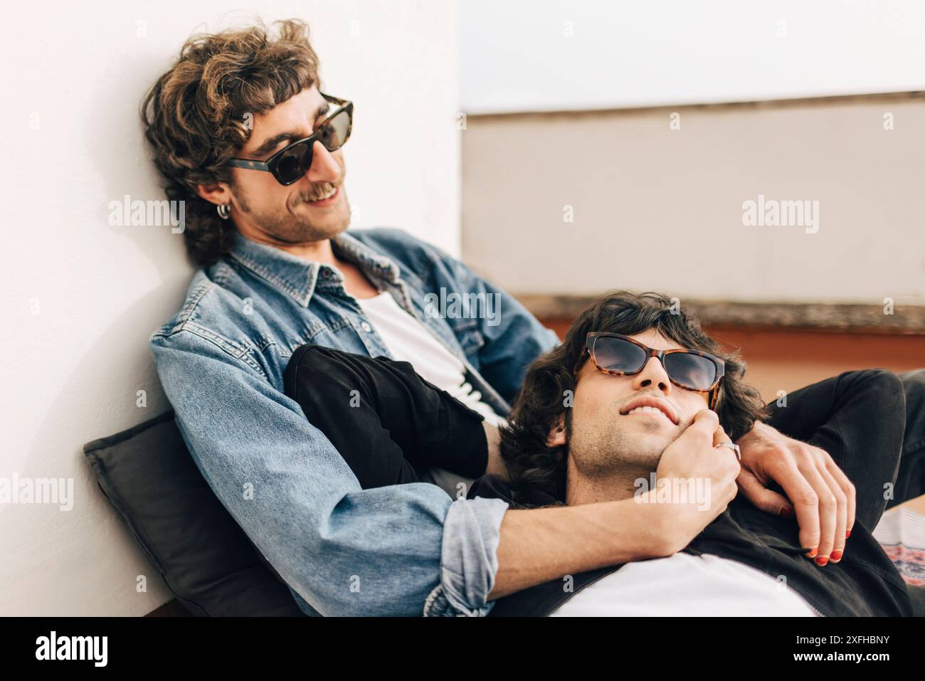 Young gay couple lying on hi-res stock photography and images - Alamy