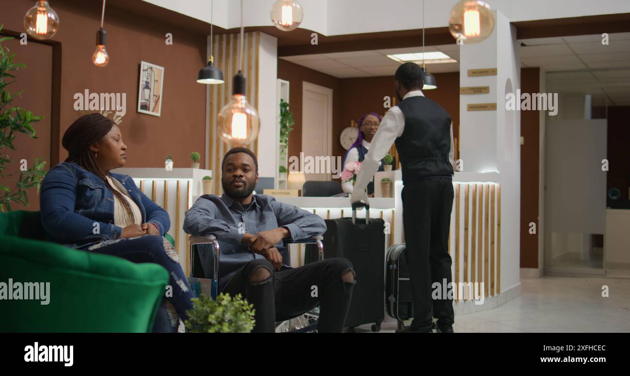 Woman wheelchair user sitting in lounge area and waiting for ...