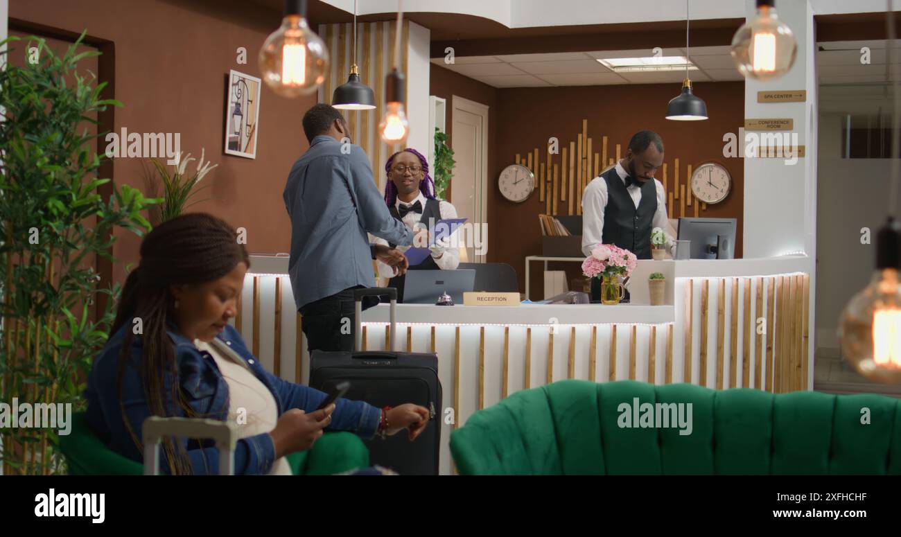 Man filling in registration forms and signing documents before seeing ...
