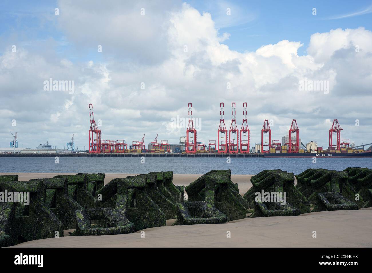 Low water exposes the Sea defences, showing a concrete pre-formed ...