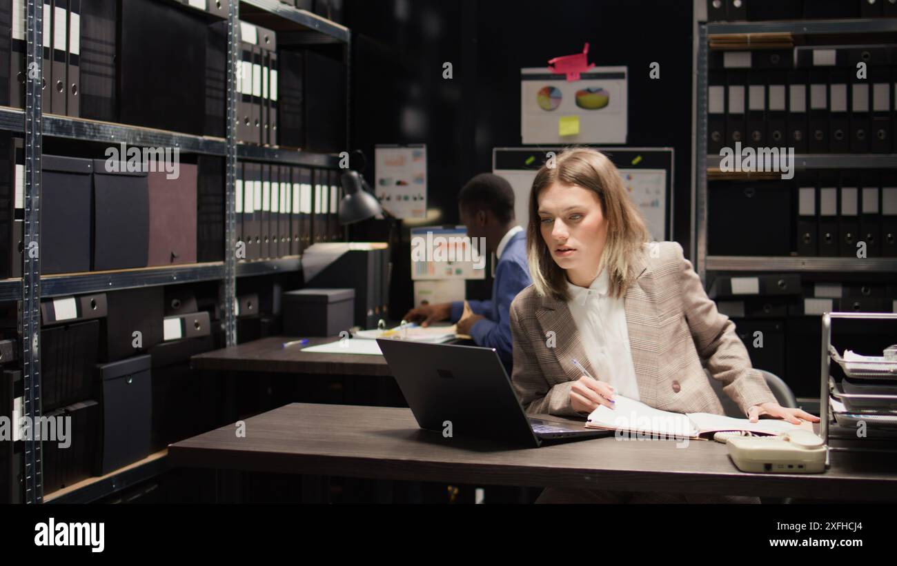 Female investigator entering workplace and sitting down to conduct ...