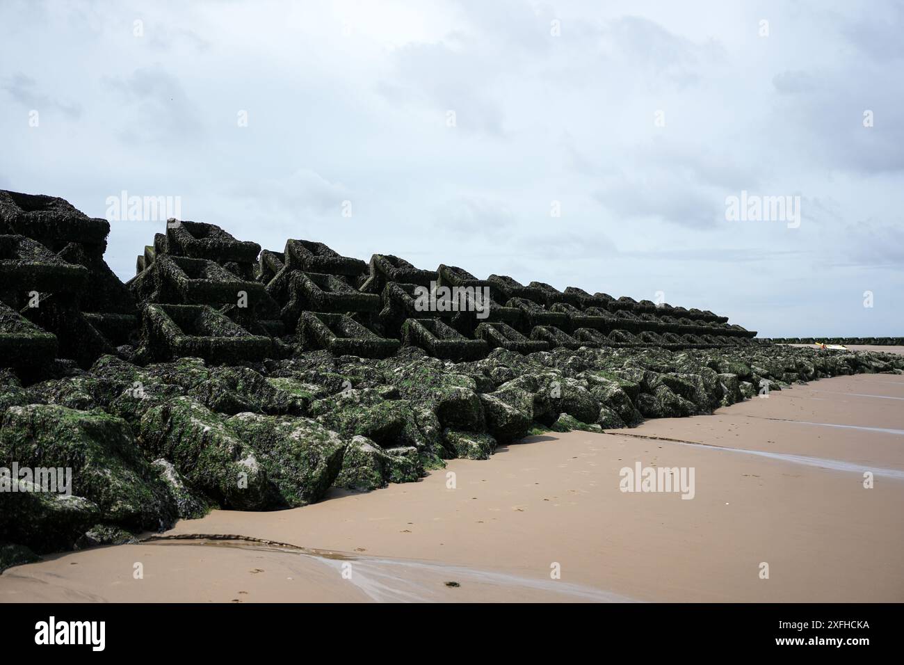 Low water exposes the Sea defences, showing a concrete pre-formed ...