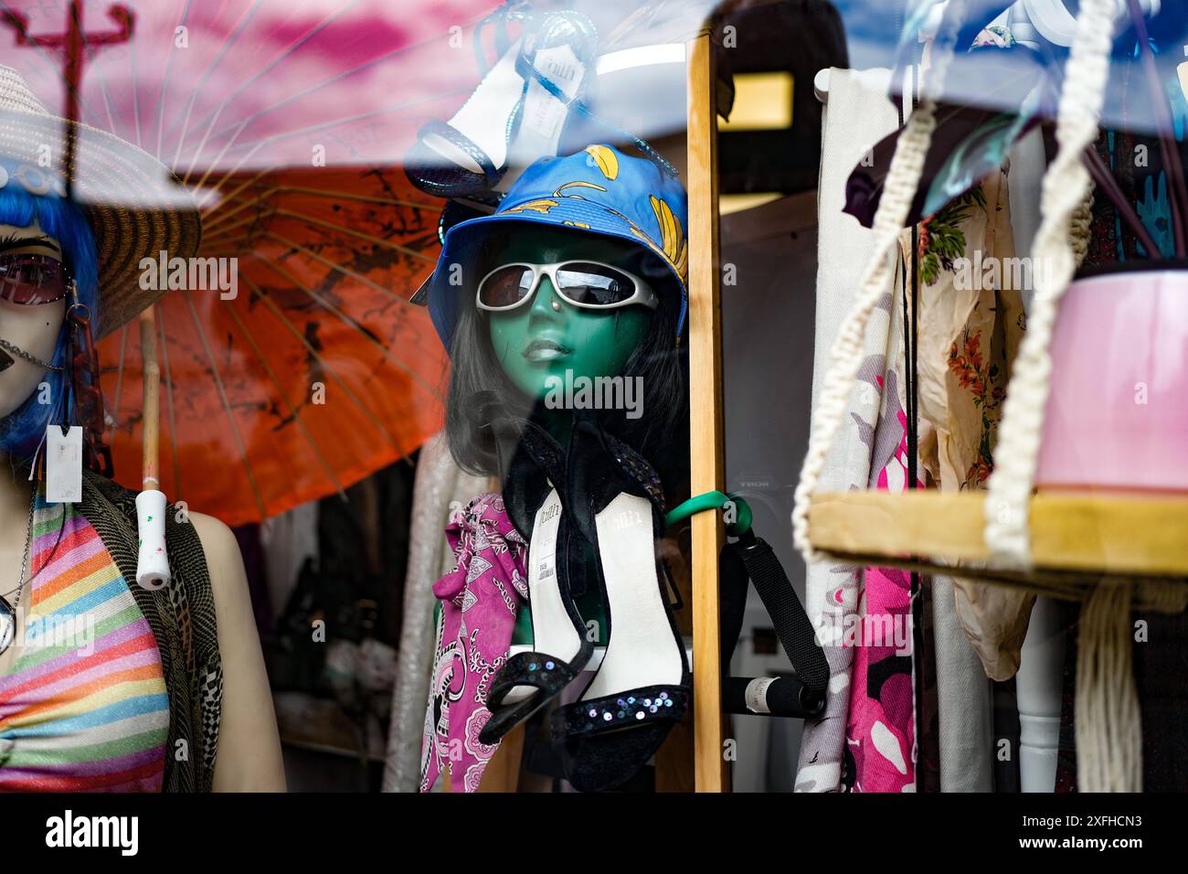 Mannequins dummies with sunglasses in a shop window Stock Photo - Alamy