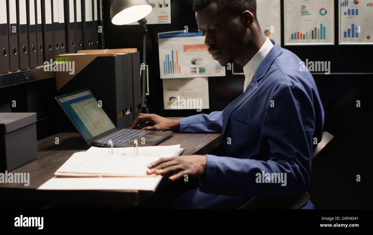 Black man with expertise in criminal investigation, analyzes files ...