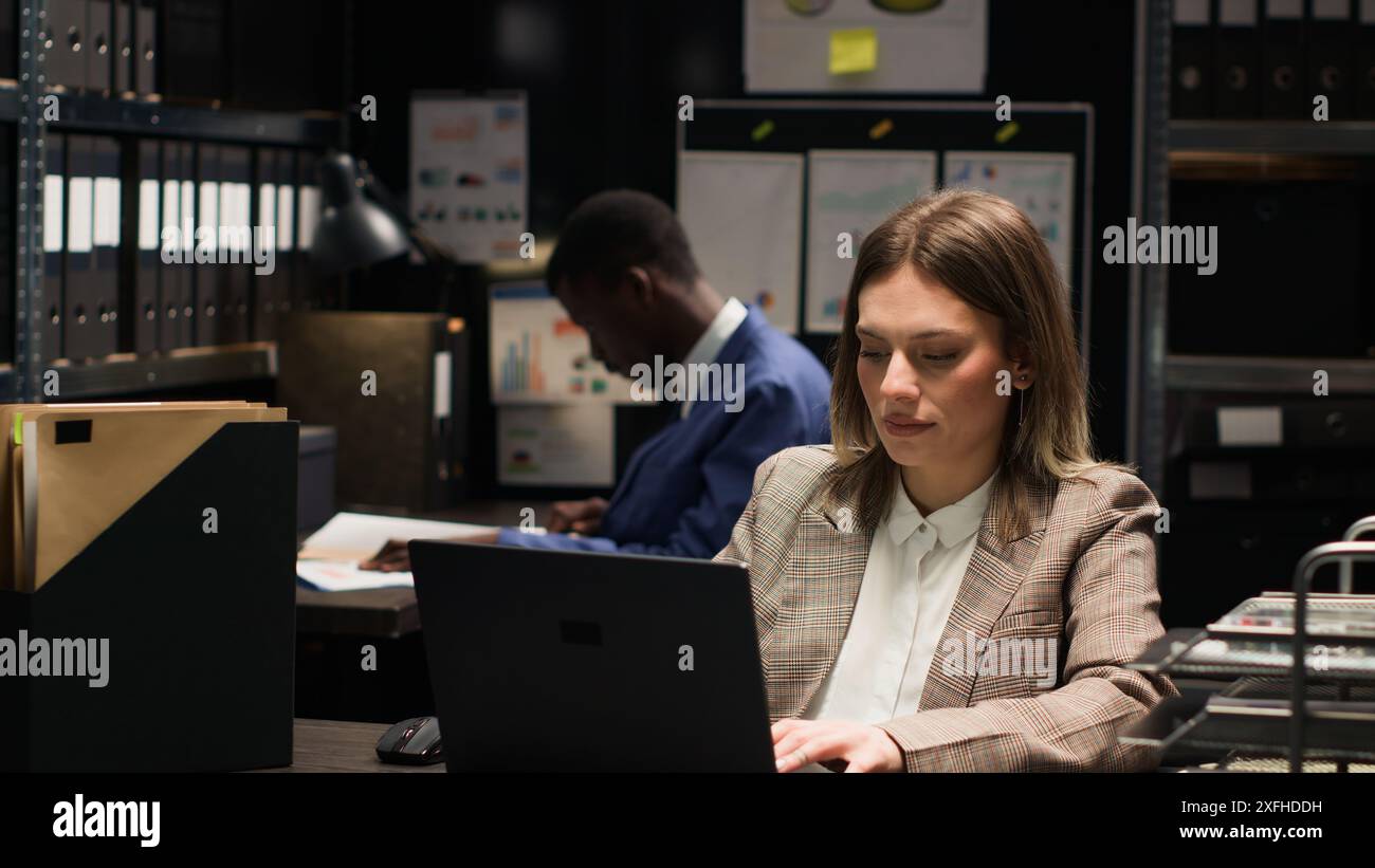 Female computer criminal checking hi-res stock photography and images ...