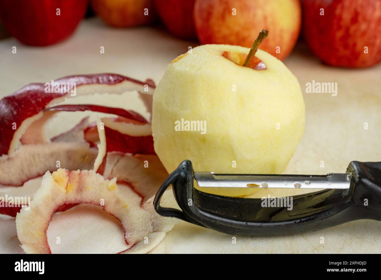 Preparing apple for a pie. Peeling gala apples Stock Photo - Alamy