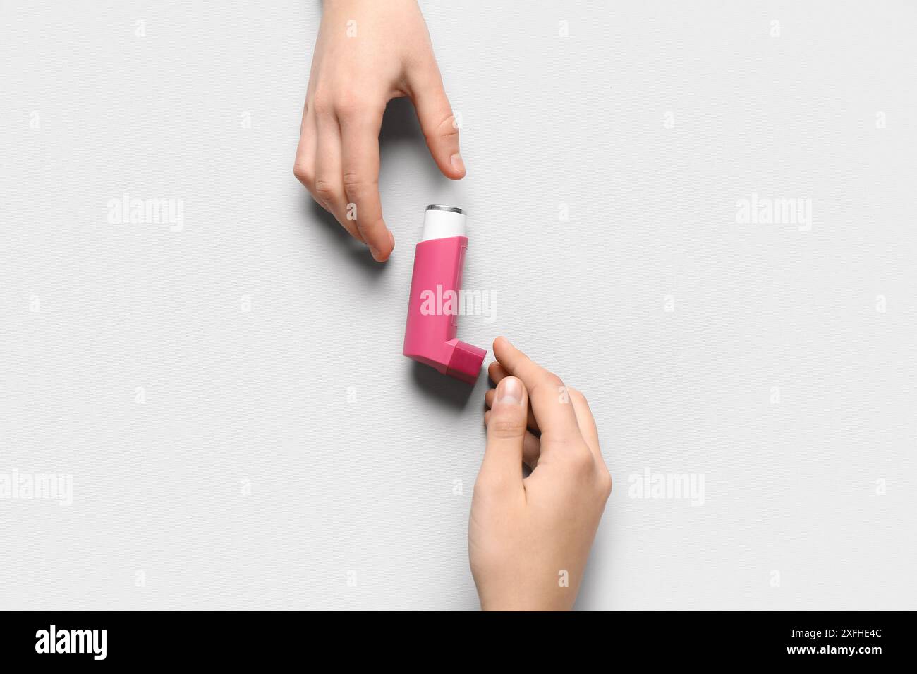 Child's hands with asthma inhaler on white background Stock Photo - Alamy