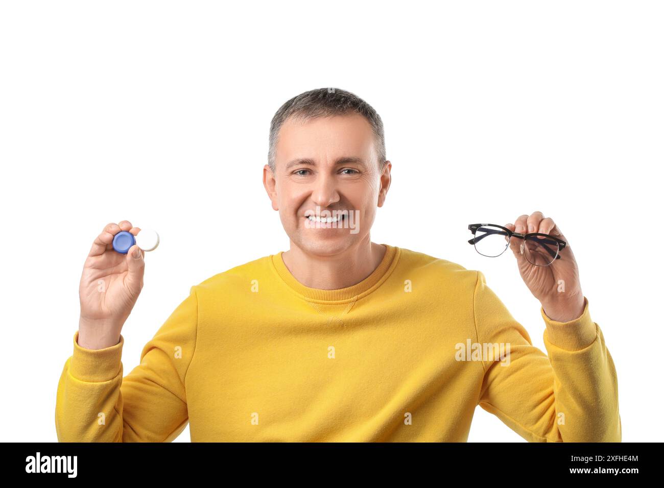Mature man with contact lens case and eyeglasses on white background ...
