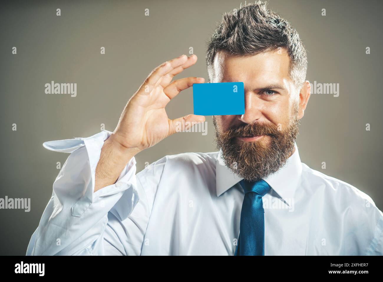 Attractive businessman with blank mockup card. Smiling bearded man ...