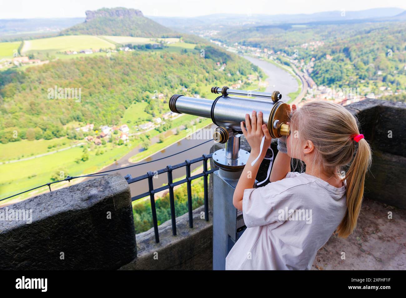 Cute curious kid girl observing Saxon Switzerland national park ...