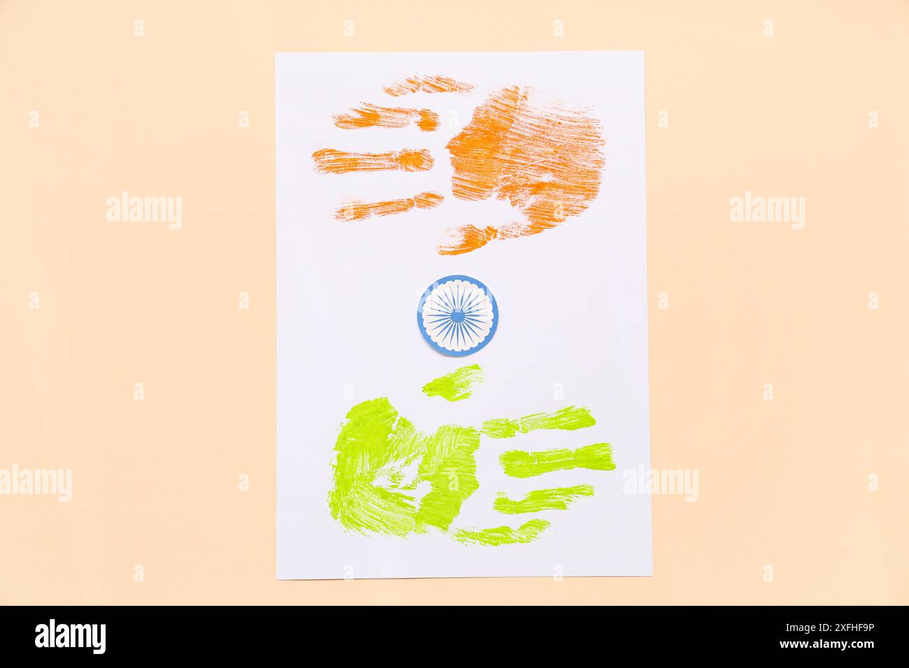 Paper sheet with palm prints in colors of Indian flag on beige ...