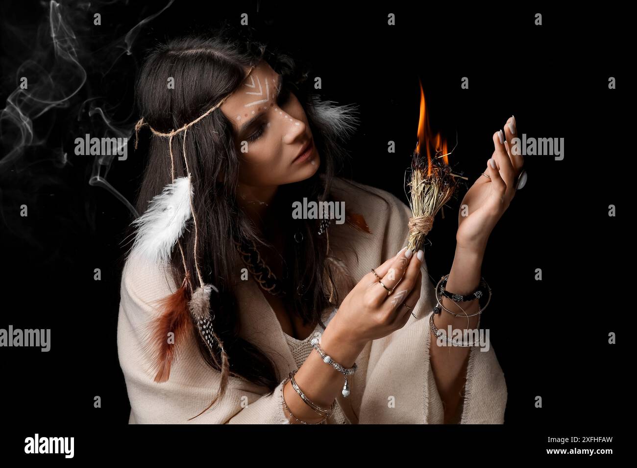 Beautiful female shaman with herbs on dark background Stock Photo - Alamy