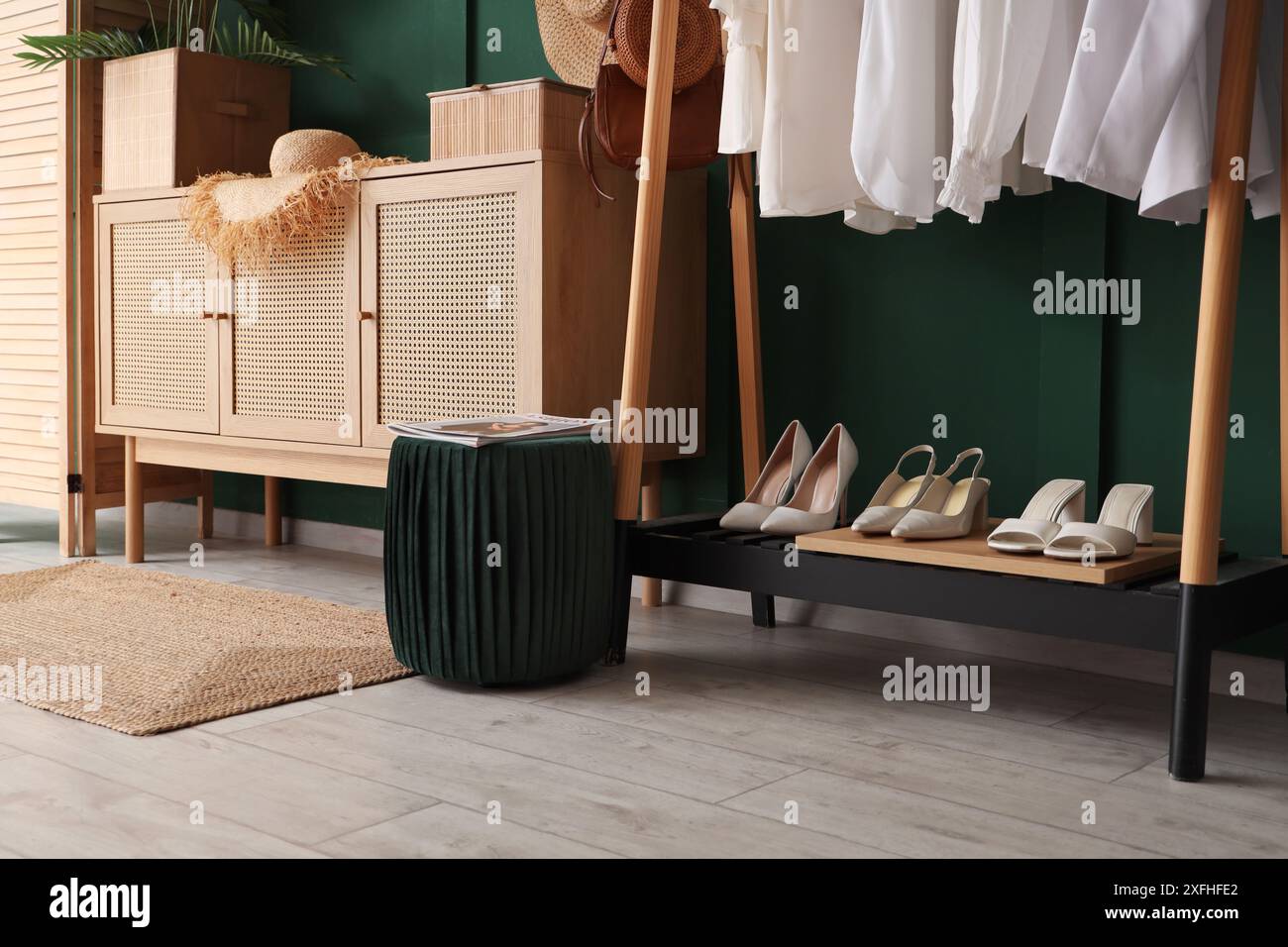 Interior of hall with commode, pouf and clothes rack Stock Photo - Alamy