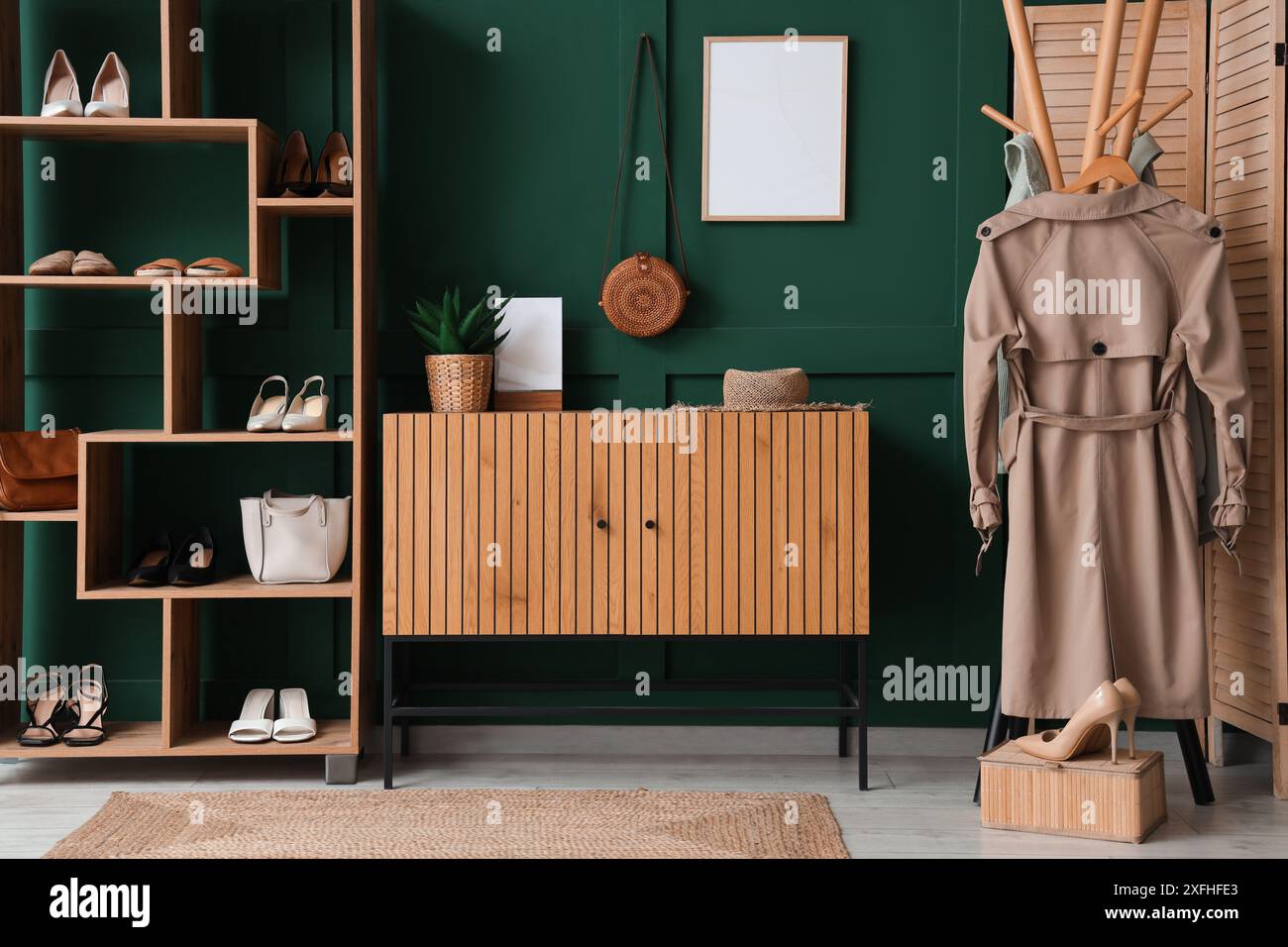Interior of hall with commode, shelf unit and coat rack Stock Photo - Alamy