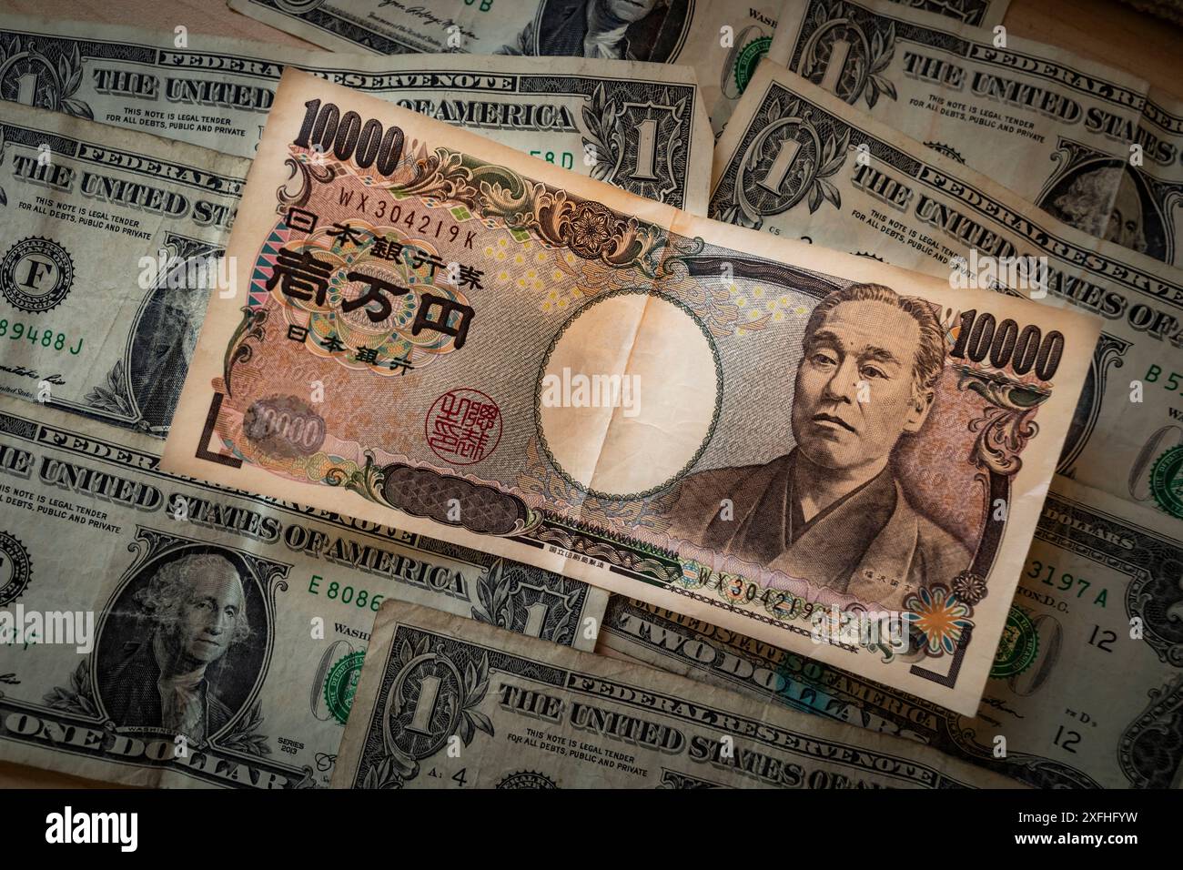 July 3, 2024, Tokyo, Japan: Stock images of a 10,000 Yen note and $1 US ...