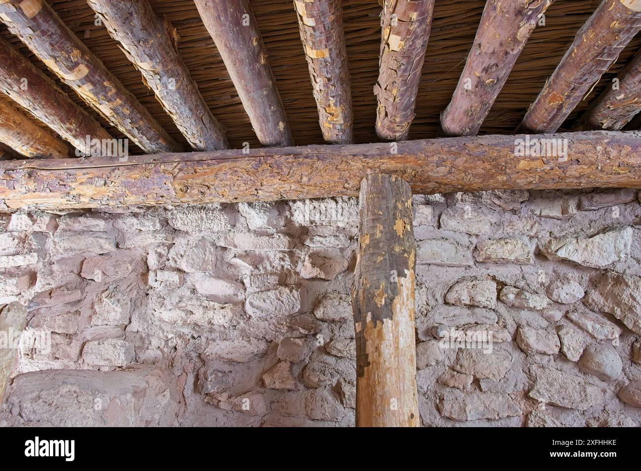 Restored roof post, beams and cat-tail reed roof atop masonry wall at ...