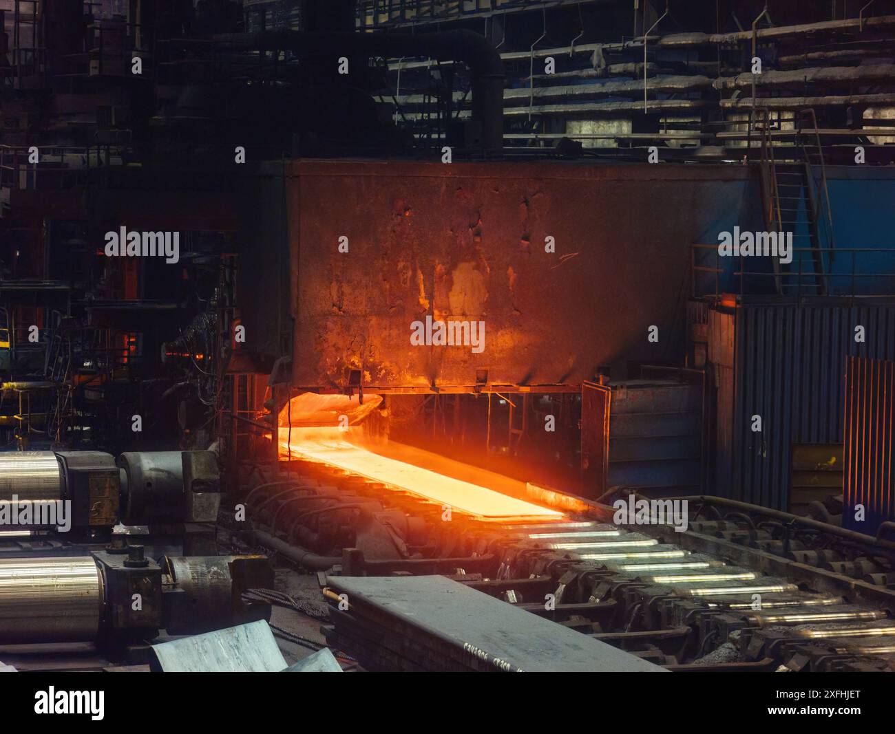 Rolled metal factory. Hot iron slab moving on conveyor of metal rolling mill Stock Photo - Alamy